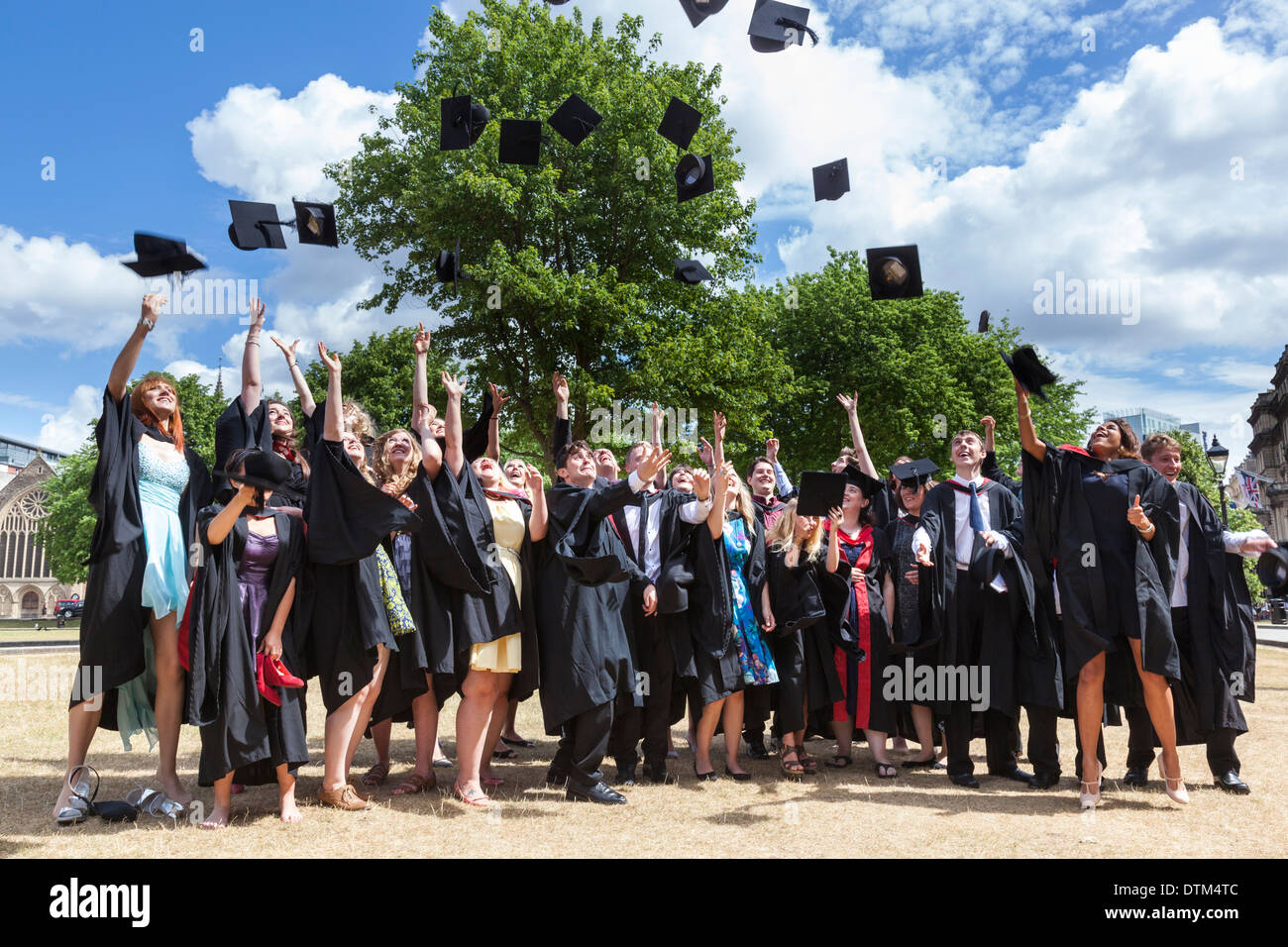 Graduates celebrate their graduation by throwing their mortar boards ...