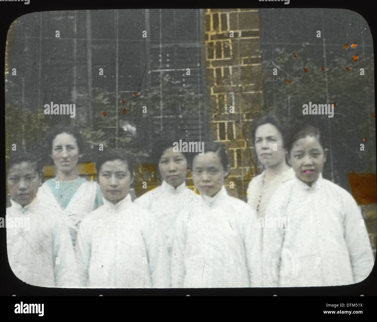 A photograph of two adult women standing with younger schoolgirls in ...