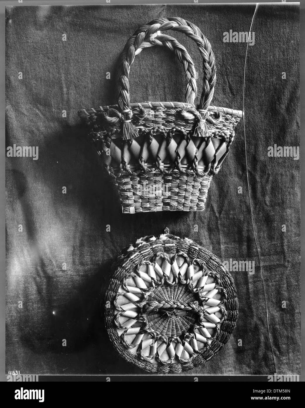 The photograph shows two Indian baskets displayed against a cloth ...