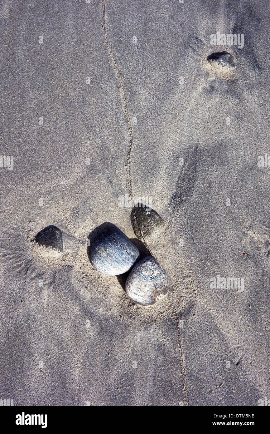 Pebbles and patterns in the sand on a beach in South Uist, Outer ...