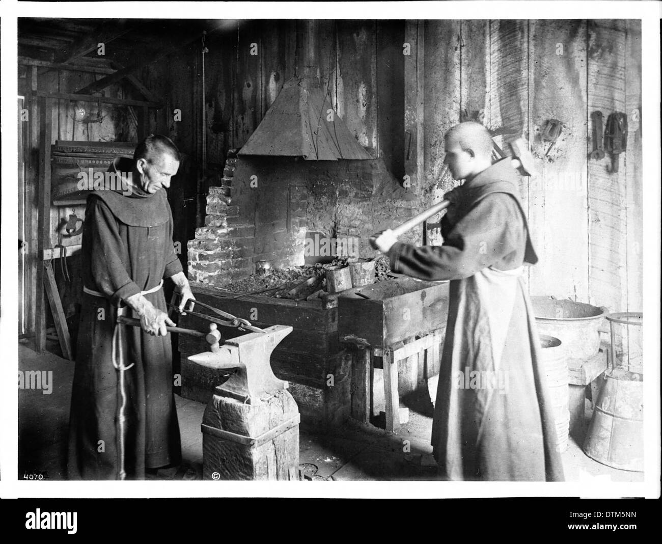 Two monks are working in the blacksmith shop at Mission Santa Barbara ...