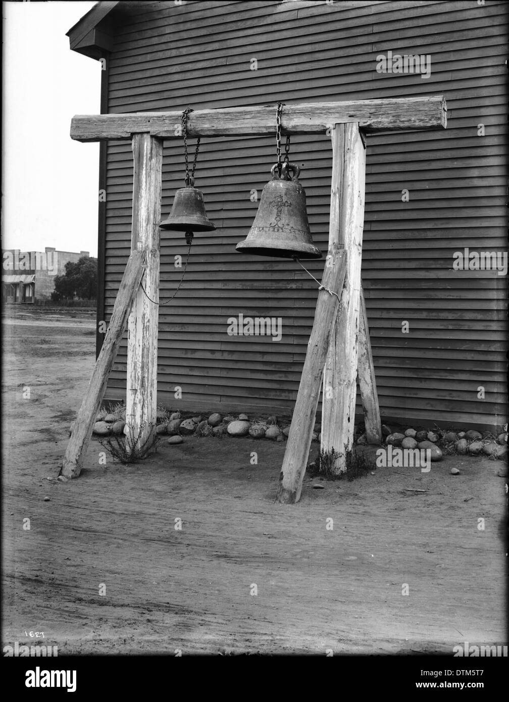 This photograph depicts two old bells from the San Diego Mission ...