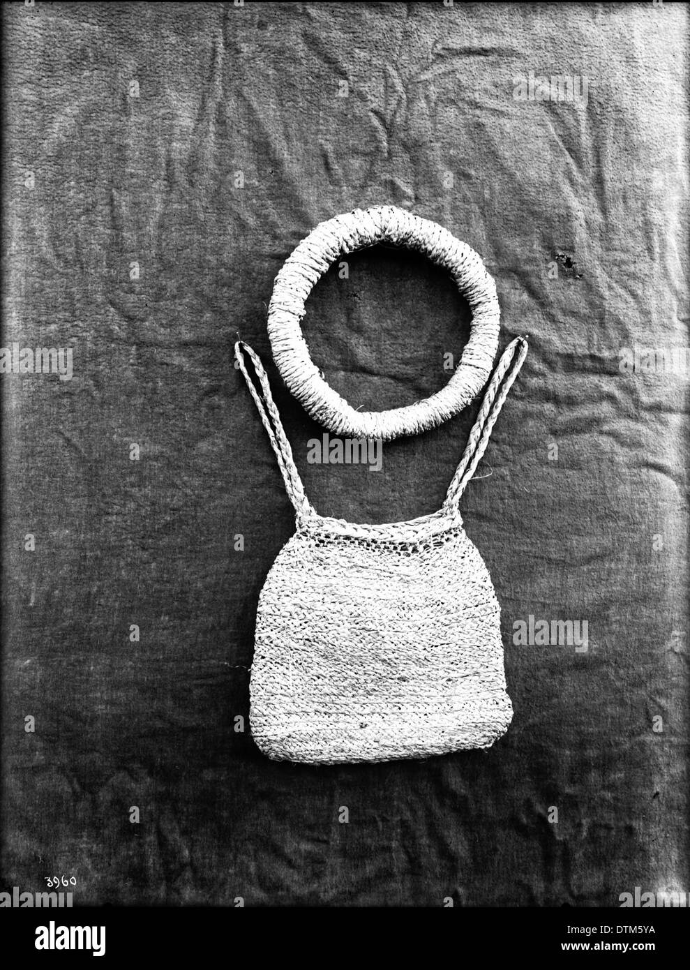 A photograph of two unidentified woven items on display, likely ...