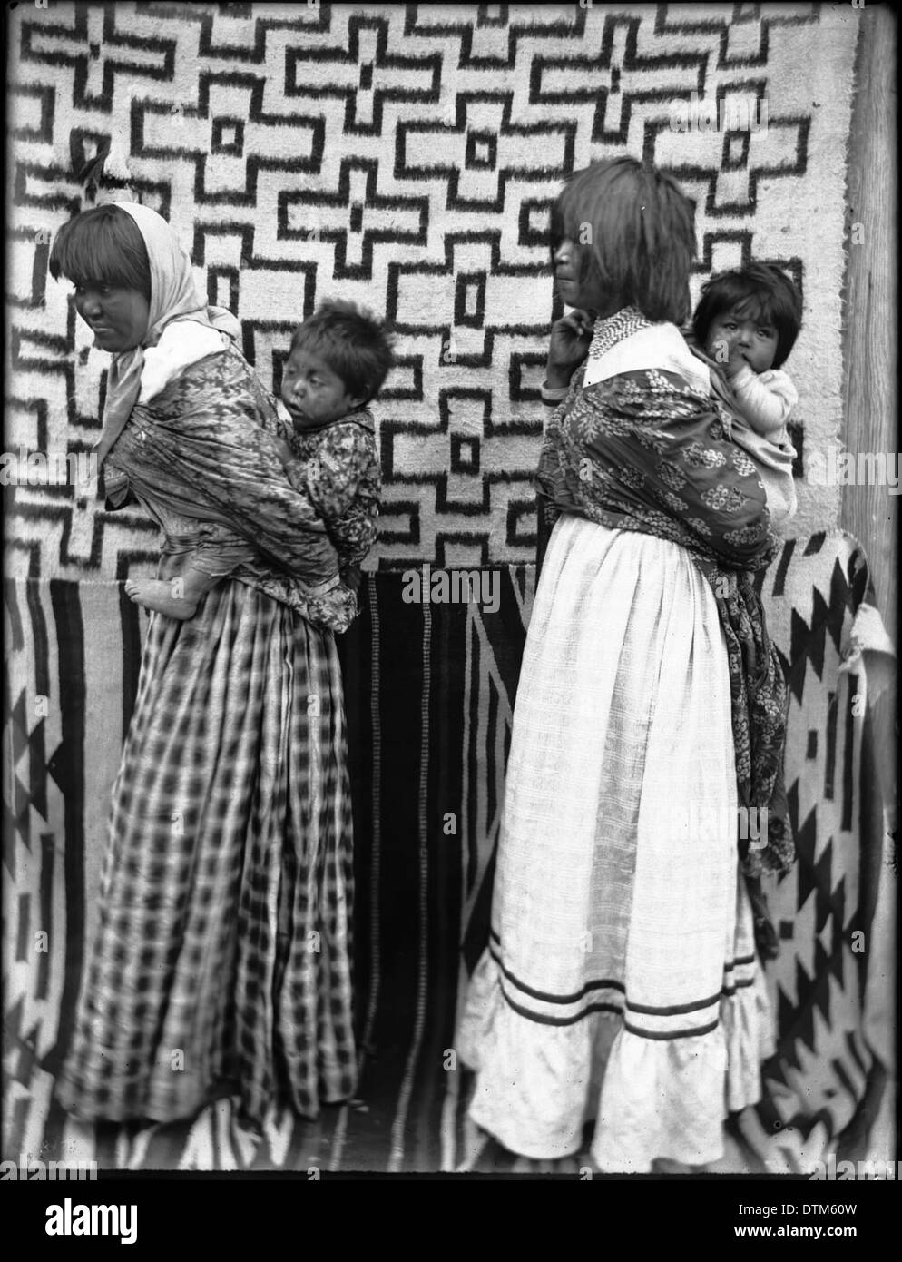 Two young Walapai Indian mothers carrying their children on their backs ...