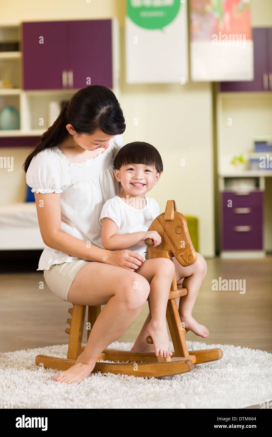 Mother daughter sitting wooden chair hi-res stock photography and ...