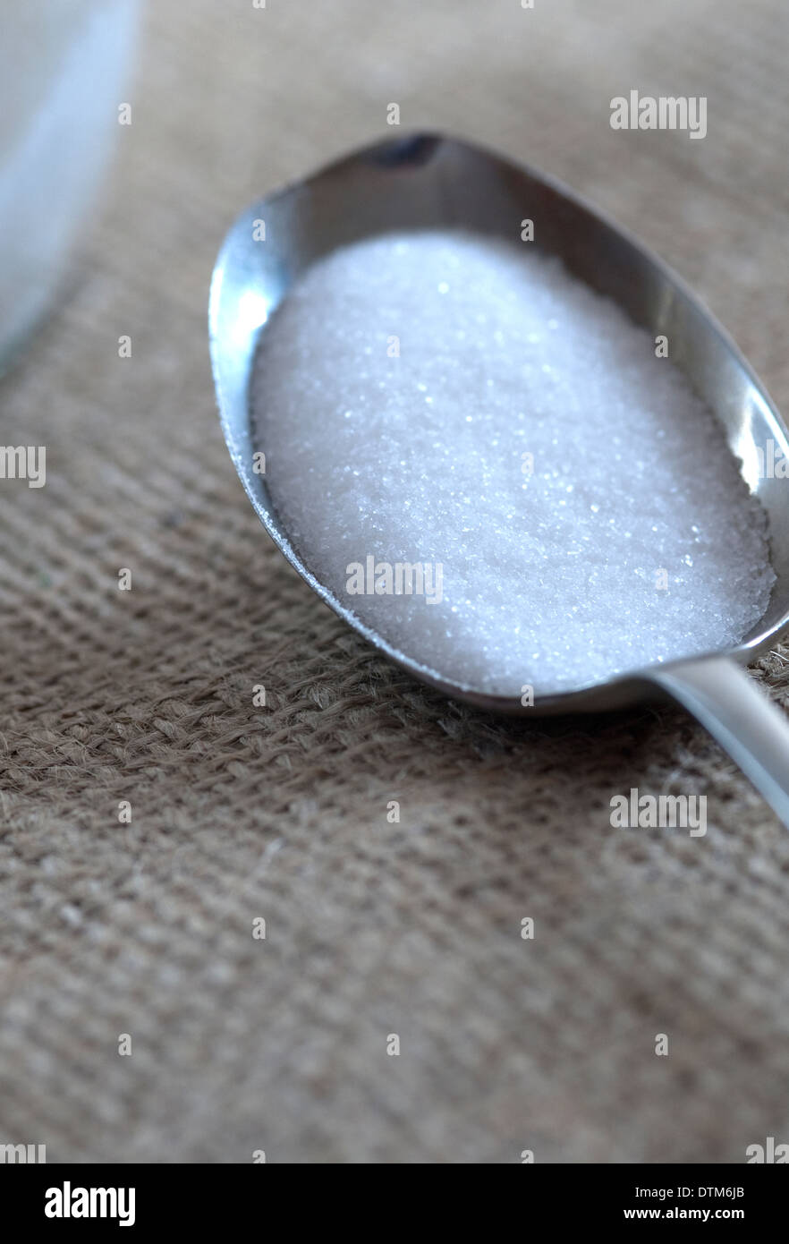 Still life food image of sugar on a spoon Stock Photo - Alamy
