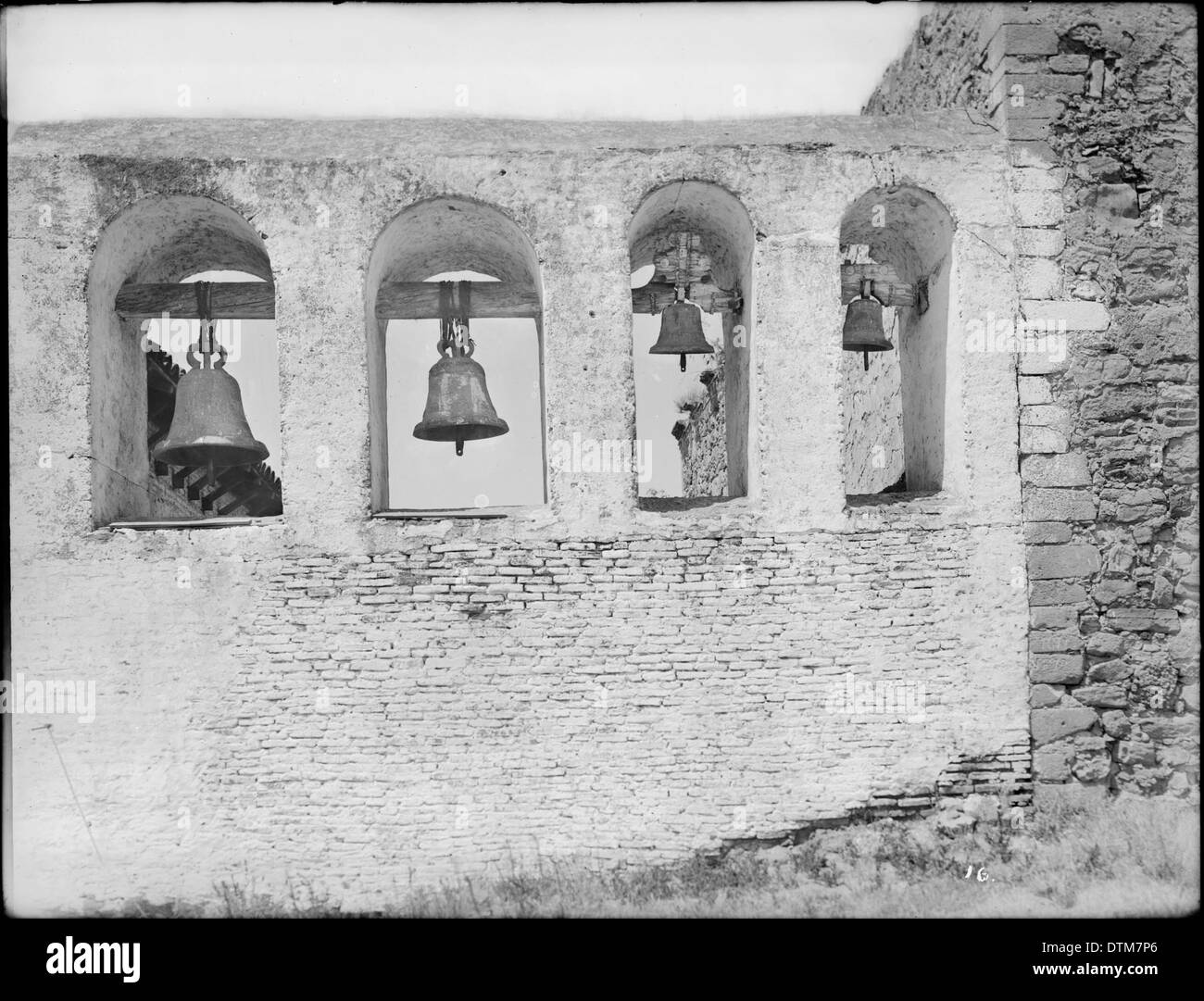 A photograph showing a front view of the bell tower of Mission San Juan ...