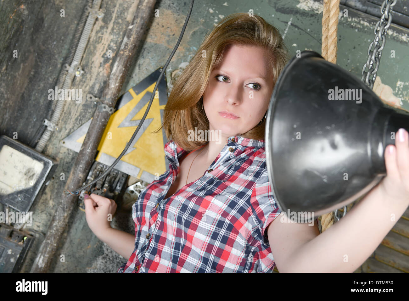 Beautiful young girl fixing electricity problems Stock Photo - Alamy