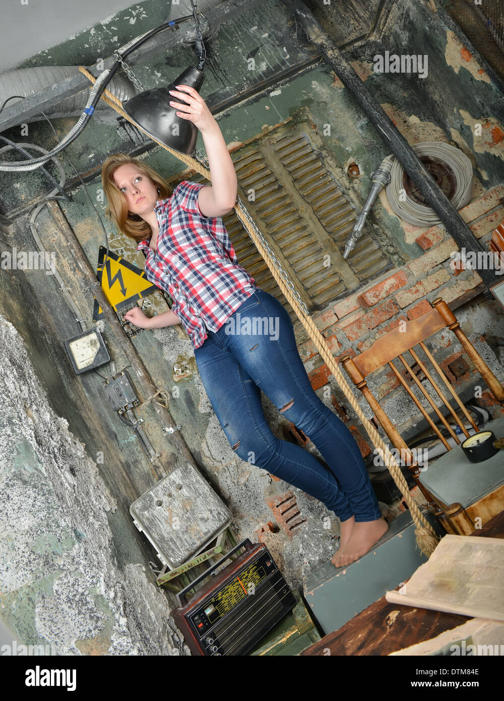 Beautiful young girl fixing electricity problems Stock Photo - Alamy