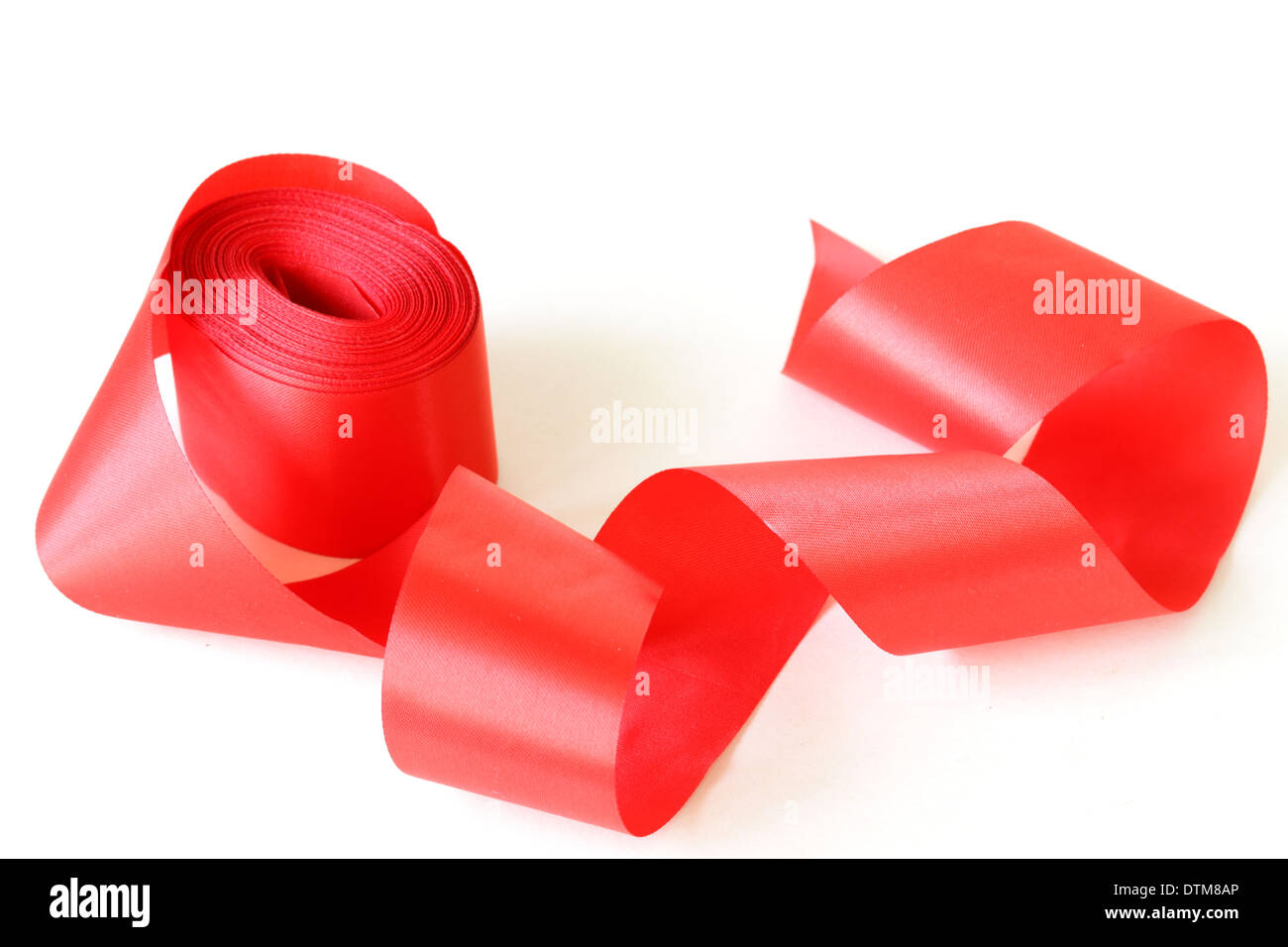 red holiday ribbon on white background Stock Photo - Alamy