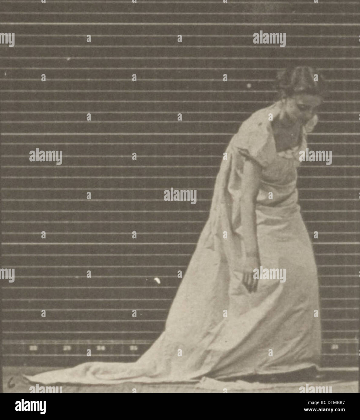 A woman in a long dress is depicted stooping and lifting a handkerchief ...