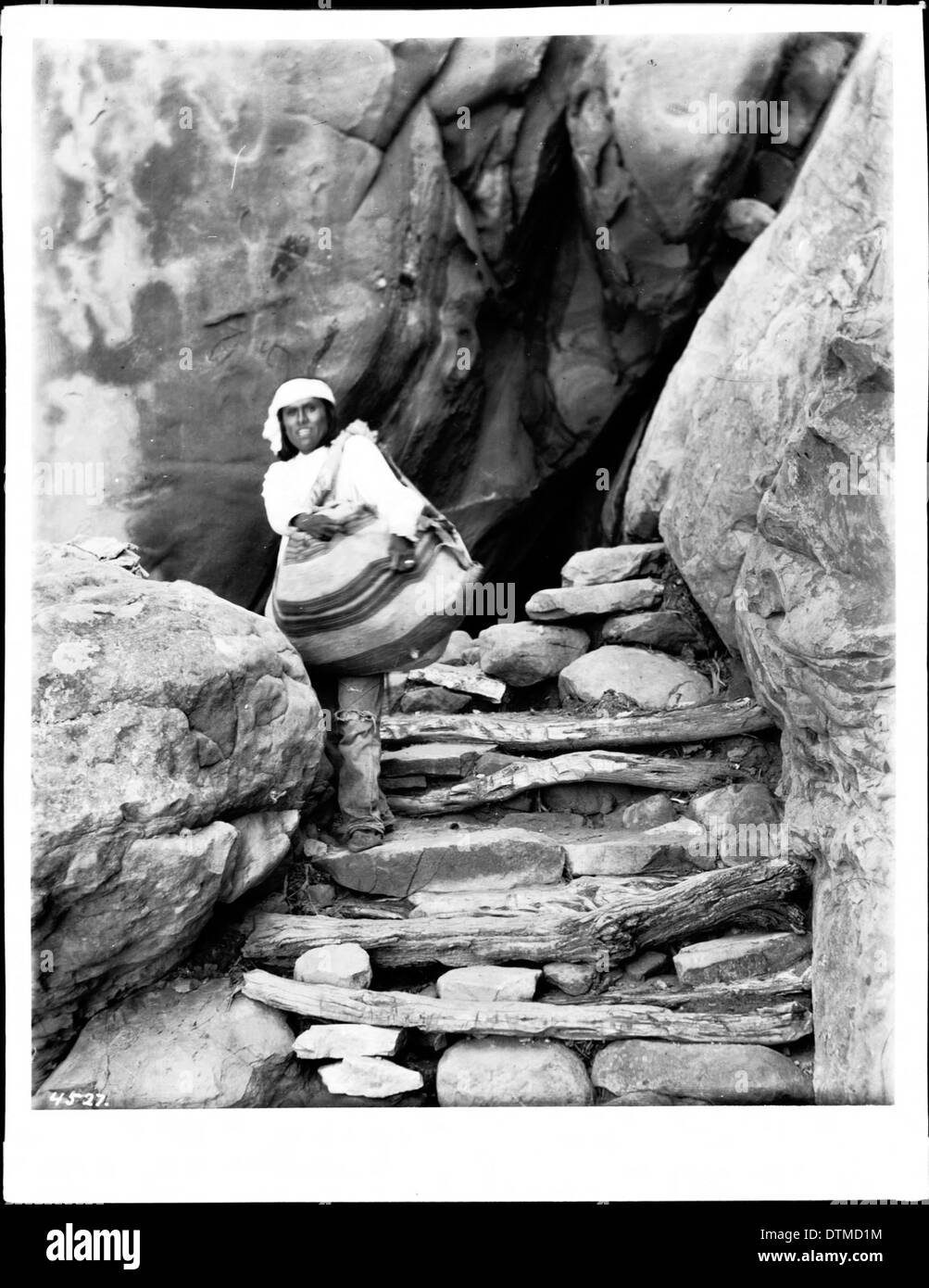 A young Acoma Indian man walking along the Acoma Trail in 1886 ...