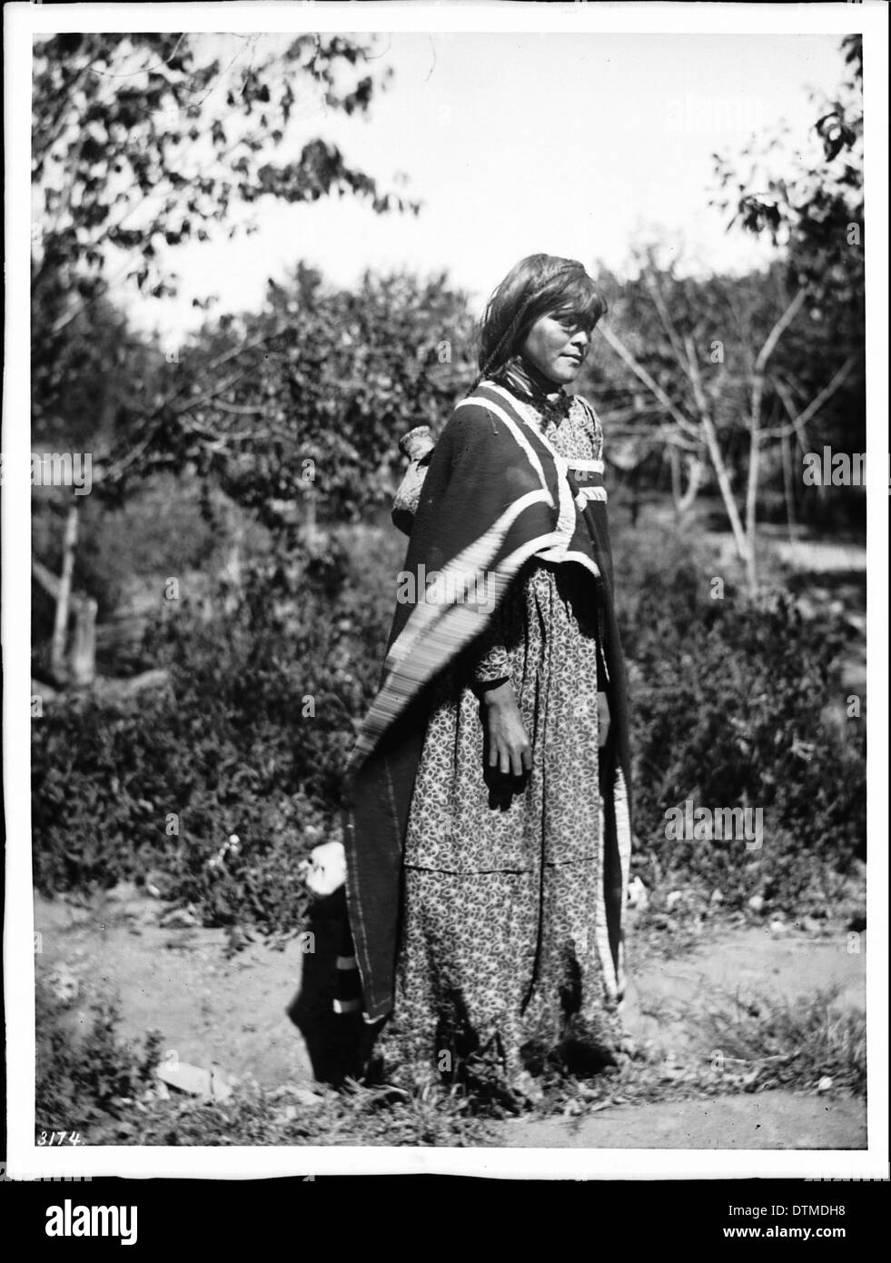 This photograph shows a young Walapai Indian girl carrying water near ...