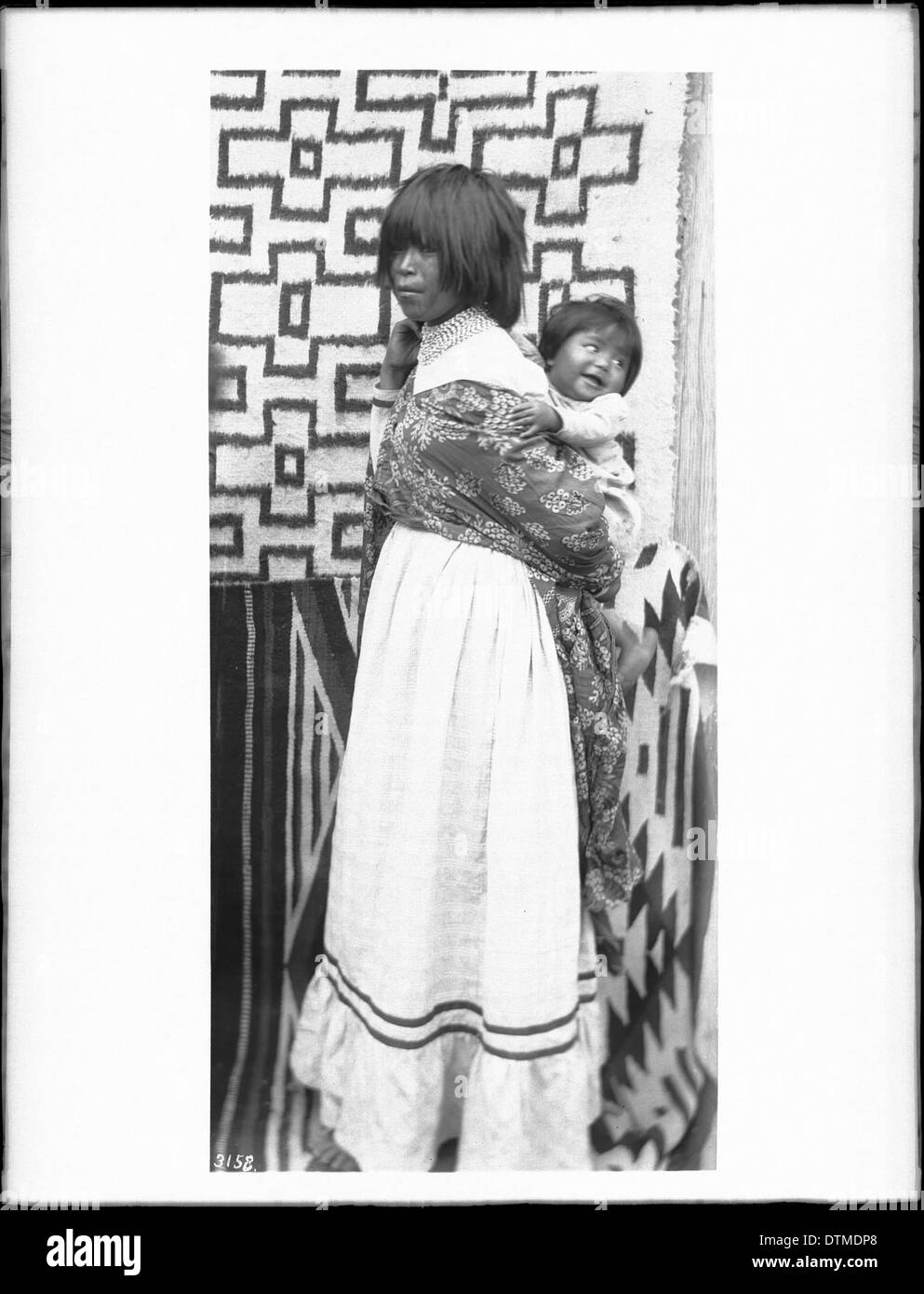 Photograph of a young Walapai Indian mother with her child on her back ...