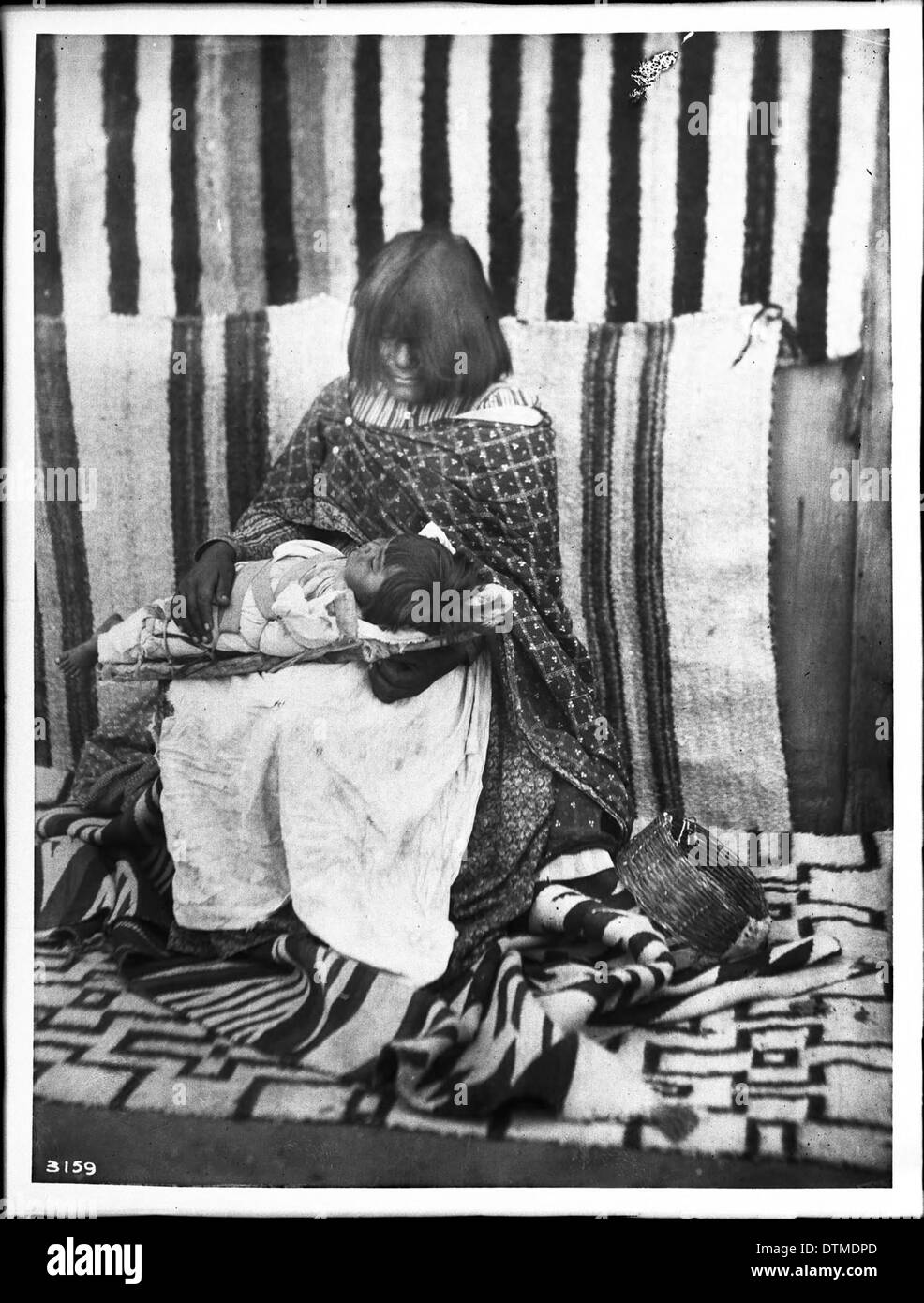 A photograph of a young Walapai Indian mother sitting with a child on ...