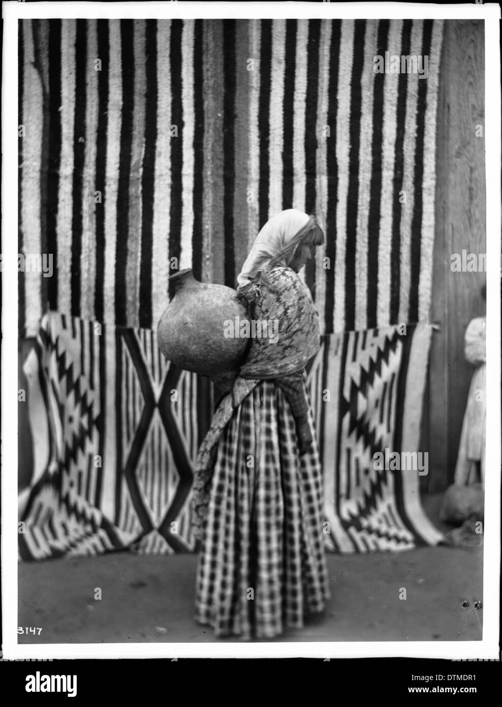 A young Walapai Indian woman is shown as a water carrier in Hackbury ...