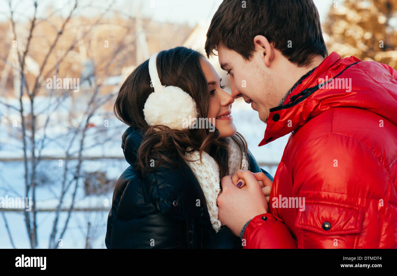 outdoor fashion portrait of young sensual couple in cold winter wather ...