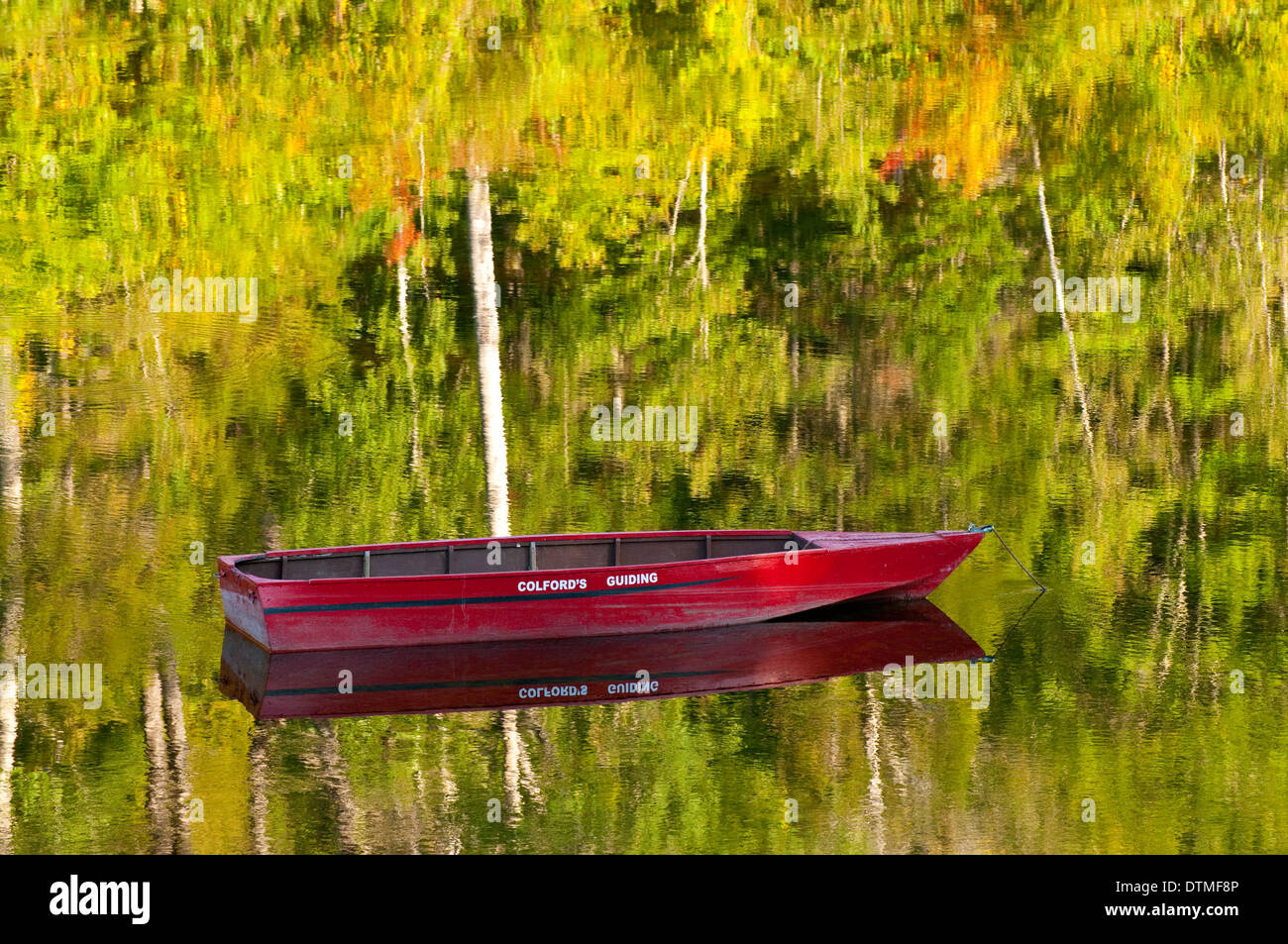 Colorful wooden red fishing boat on the Miramichi River, New Brunswick ...