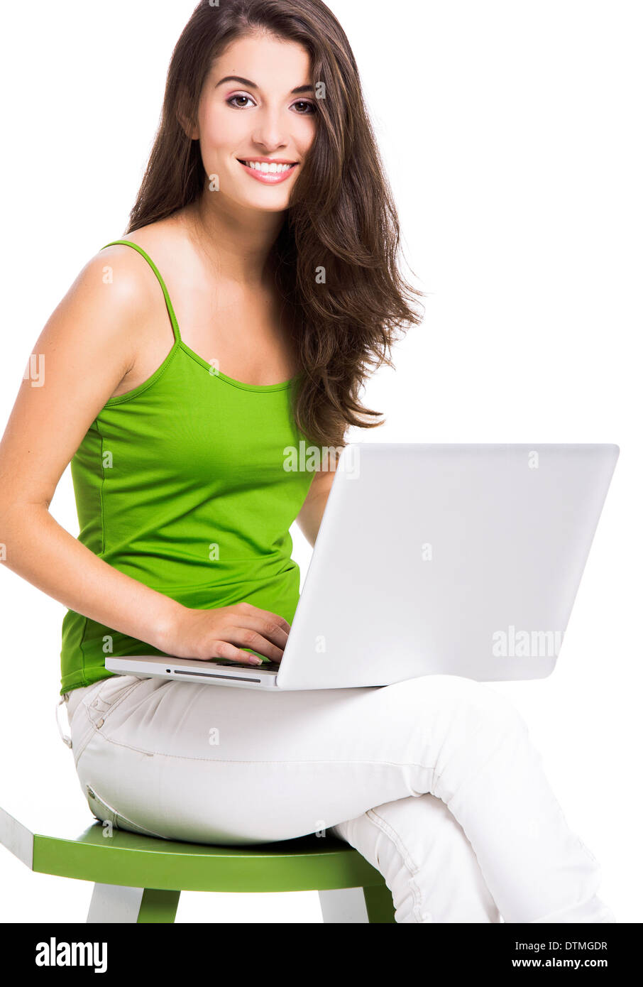 Beautiful woman sitting in a chair working with a laptop, isolated over ...