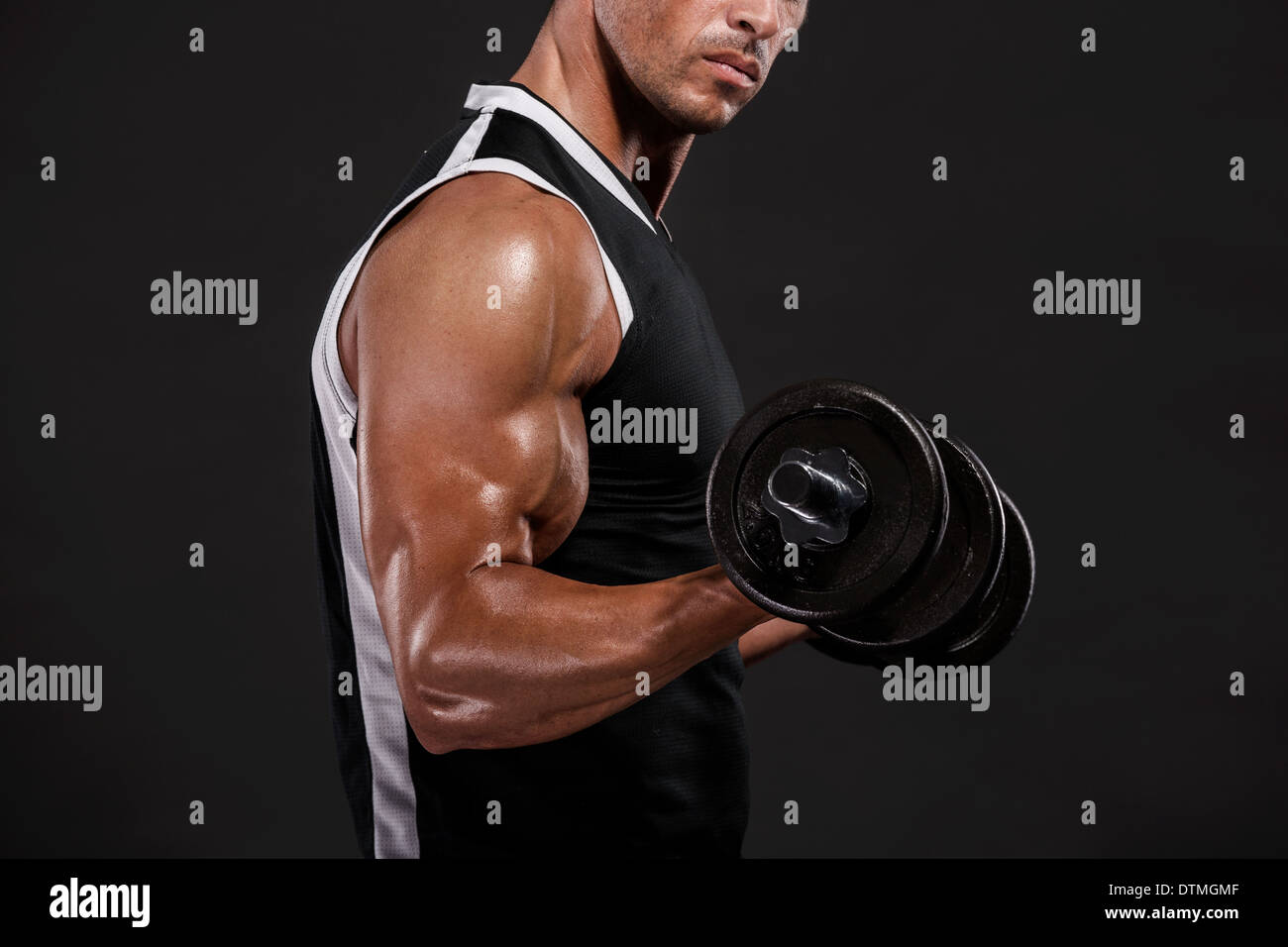 Muscle man in studio lifting weights, isolated over a white background ...