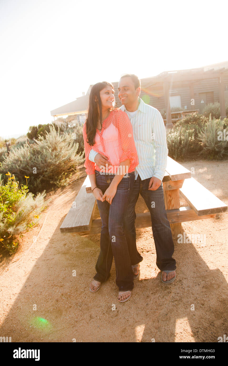 indian couple hug and smile and cuddle on a park bench Stock Photo - Alamy