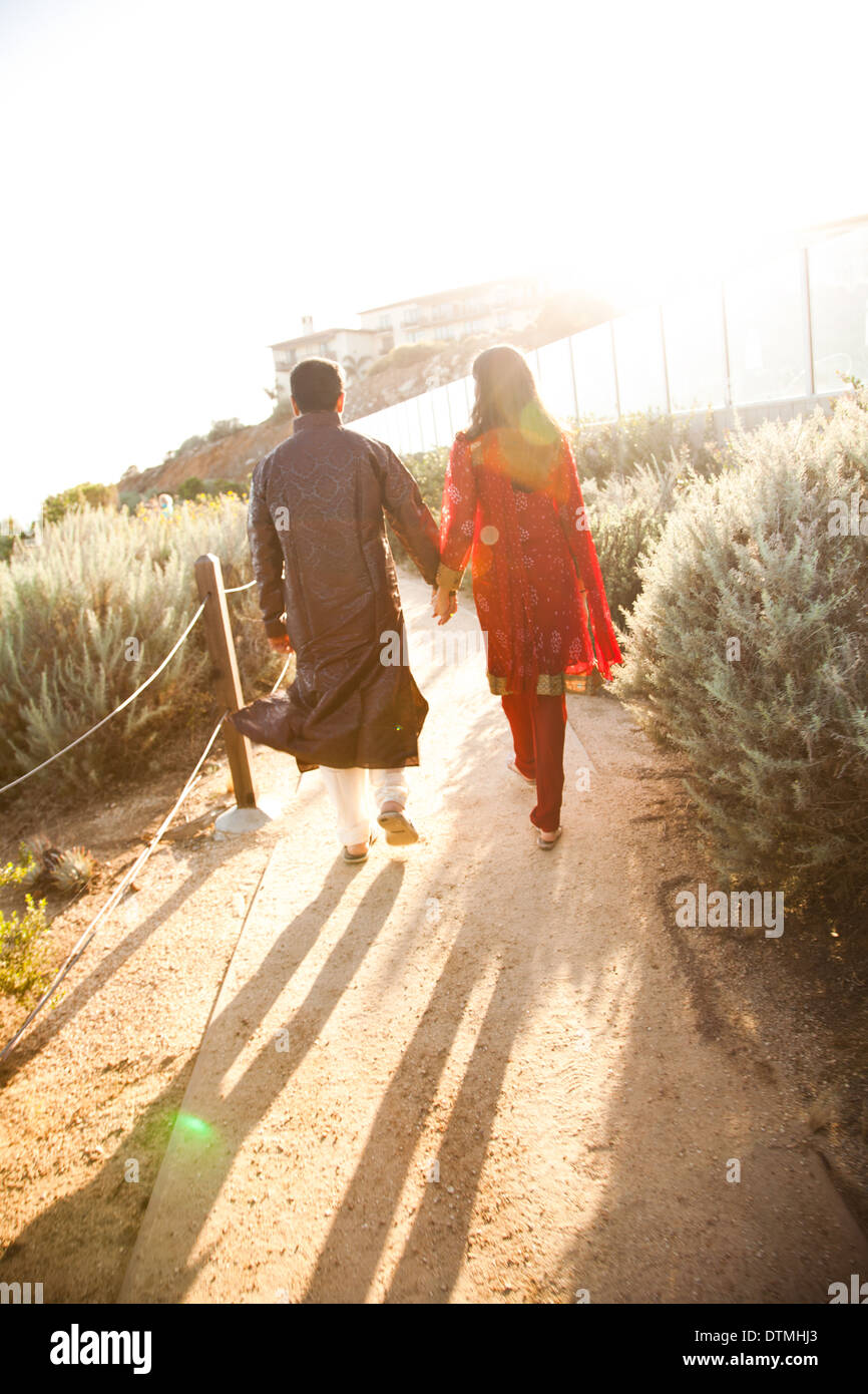indian couple walk jump and hug each other beachside oceanside seaside ...