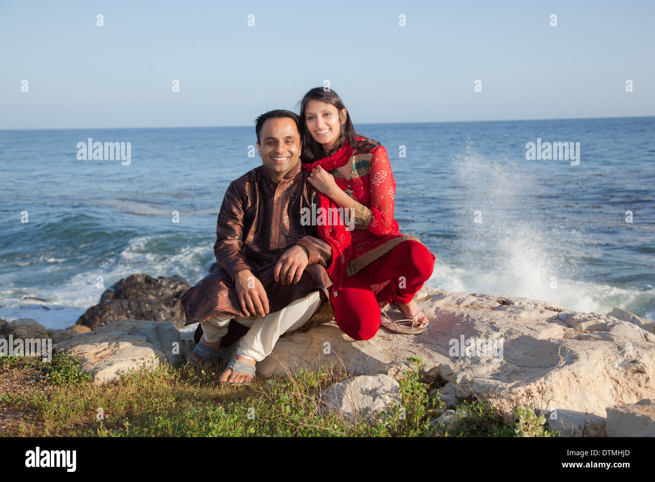 indian couple walk jump and hug each other beachside oceanside seaside ...