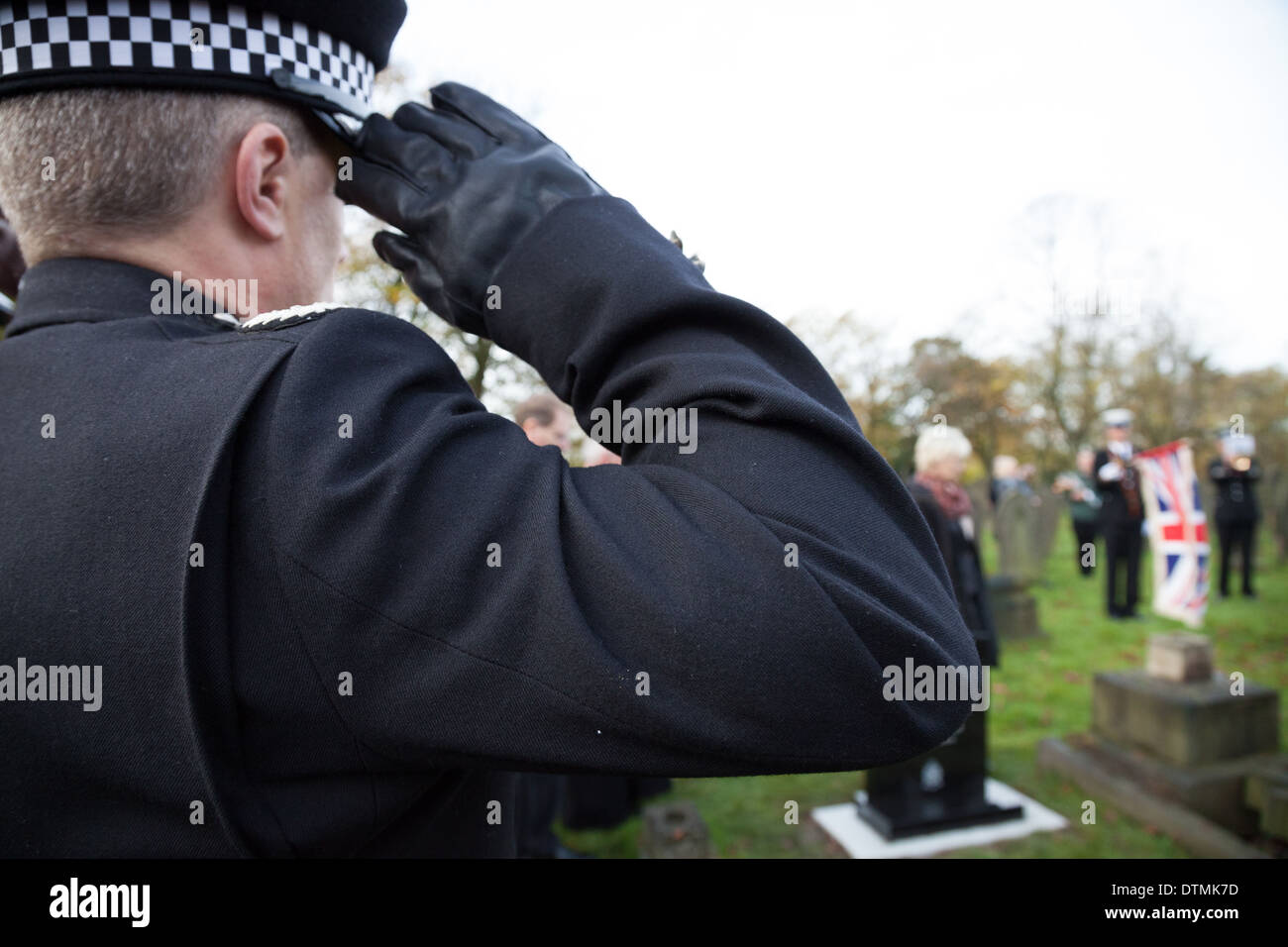 A Police officer salutes during the dedication to PC James Gordon in St ...