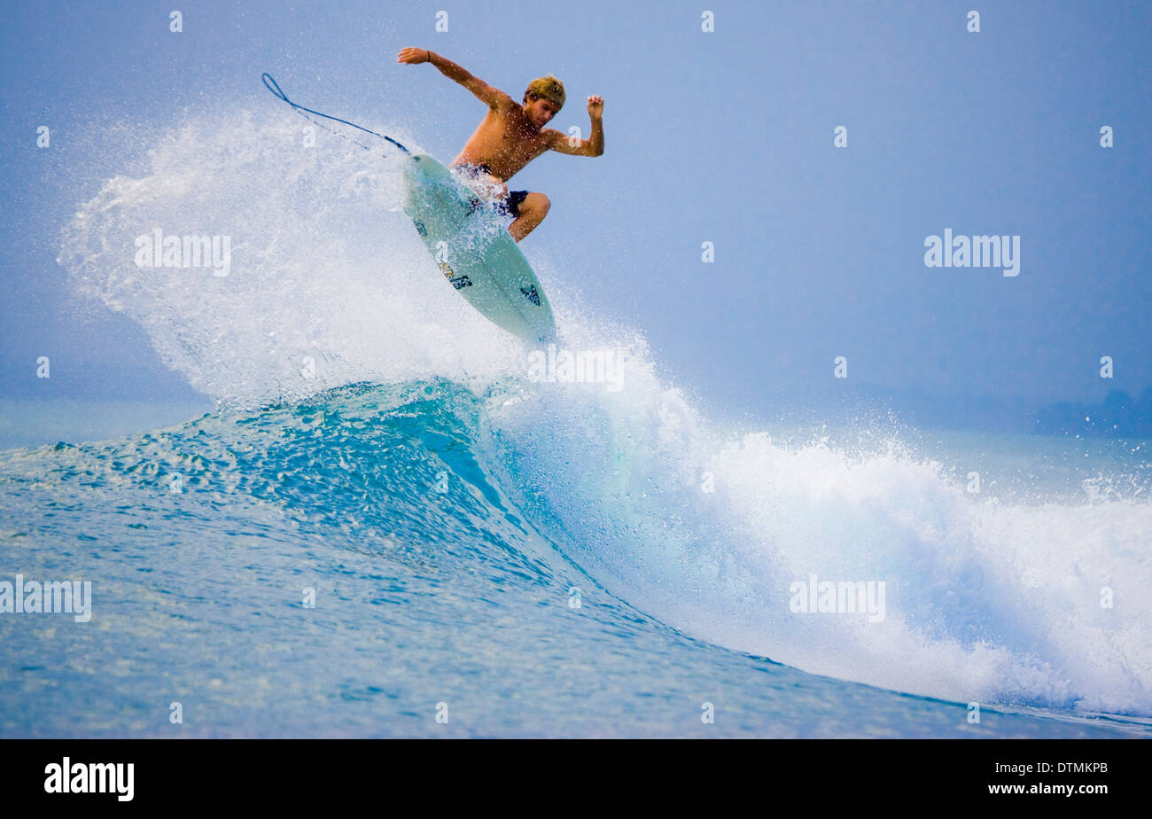 surfer on a surfboard riding a wave in the ocean sea water wave beach ...