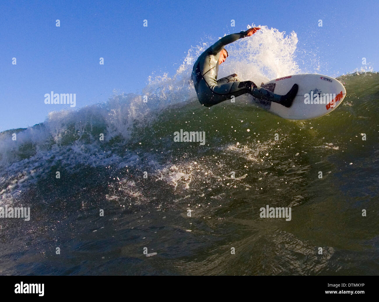 surfer on a surfboard riding a wave in the ocean sea water wave beach ...
