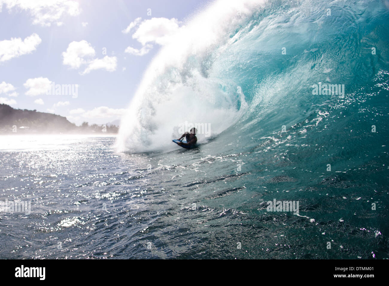surfer catching some waves in the ocean in hawaii Stock Photo - Alamy