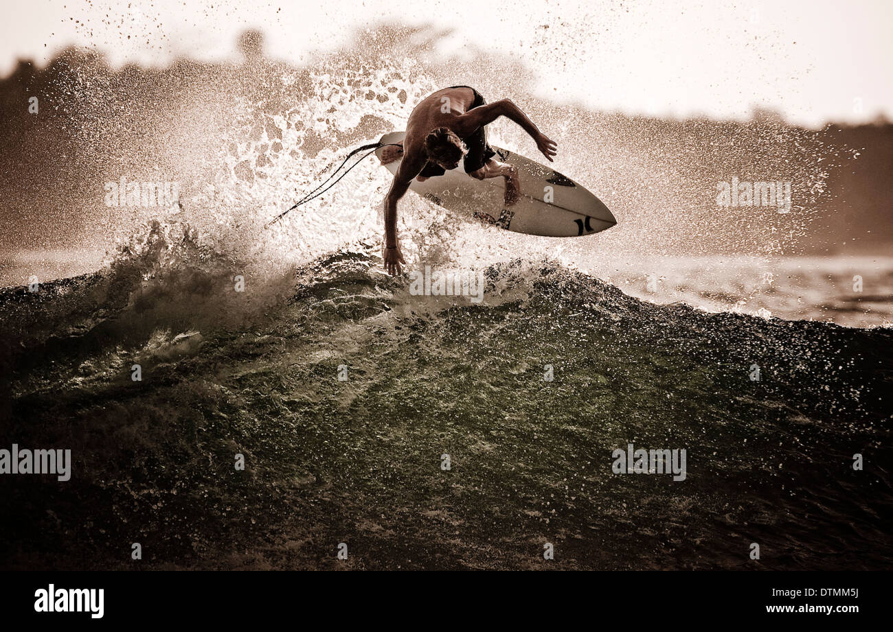 surfer on a surfboard riding a wave in the ocean sea water wave beach ...