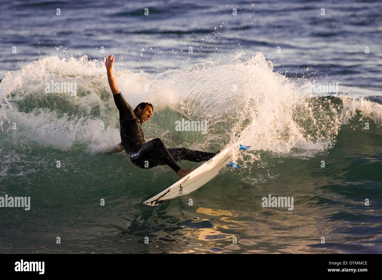 surfer on a surfboard riding a wave in the ocean sea water wave beach ...