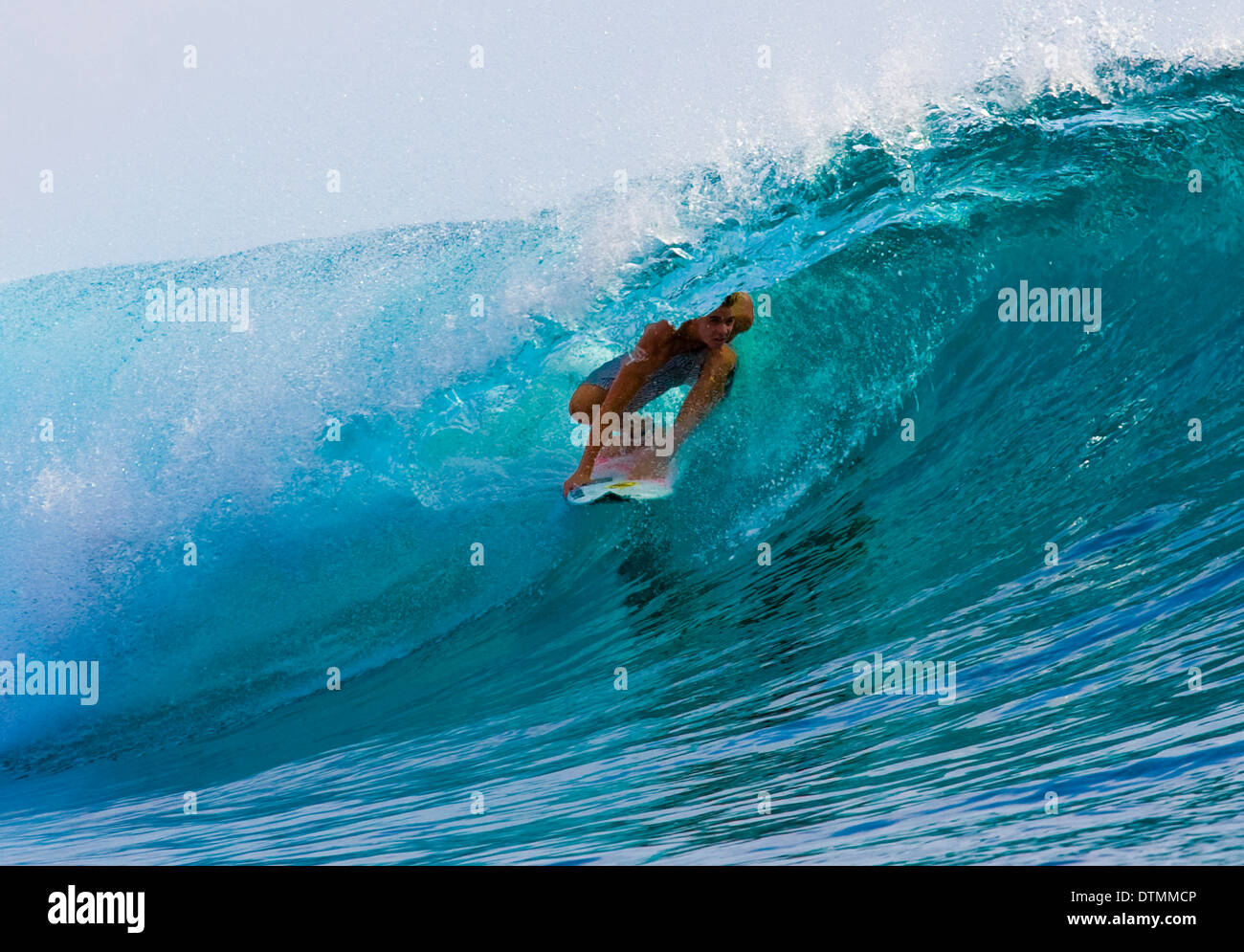 surfer on a surfboard riding a wave in the ocean sea water wave beach ...
