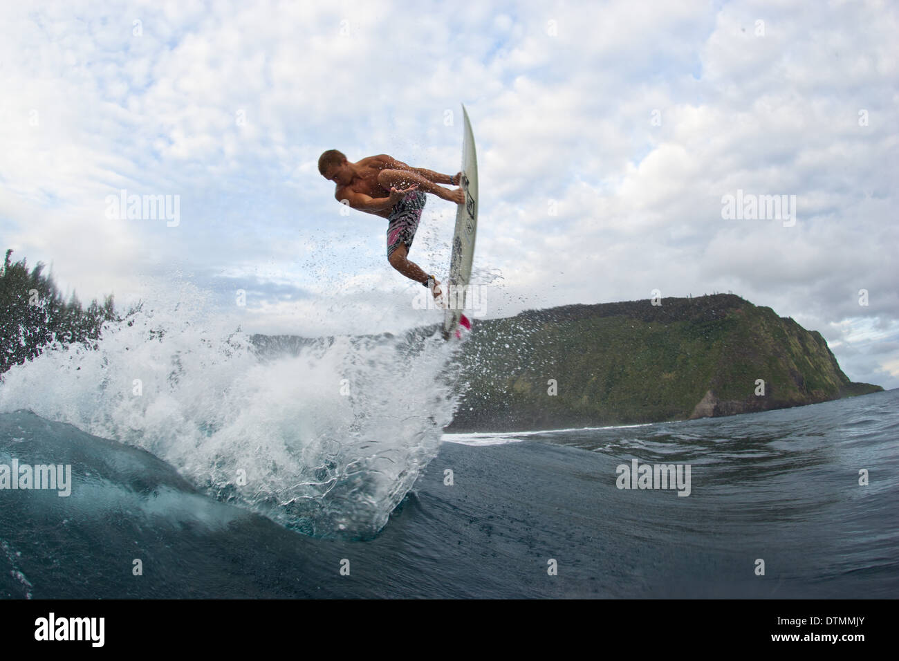 surfer jumps and catches some air on his surfboard while surfing in ...
