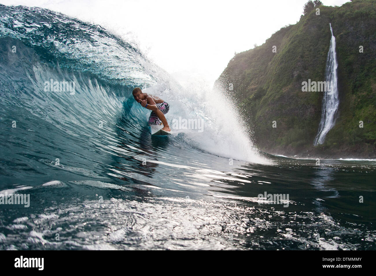 hawaii waterfall and surfer in barrel of water wave ocean sea Stock ...