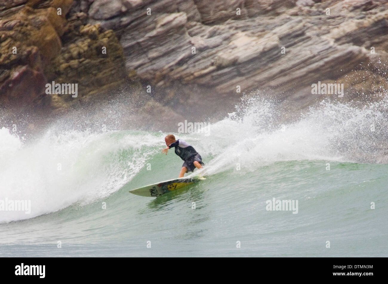 surfer on a surfboard riding a wave in the ocean sea water wave beach ...