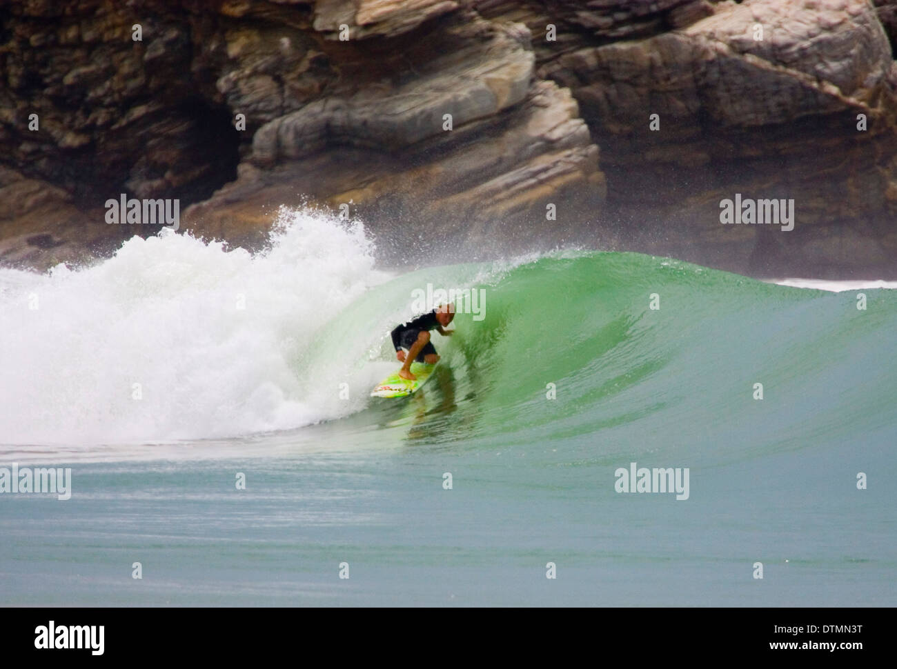 surfer on a surfboard riding a wave in the ocean sea water wave beach ...