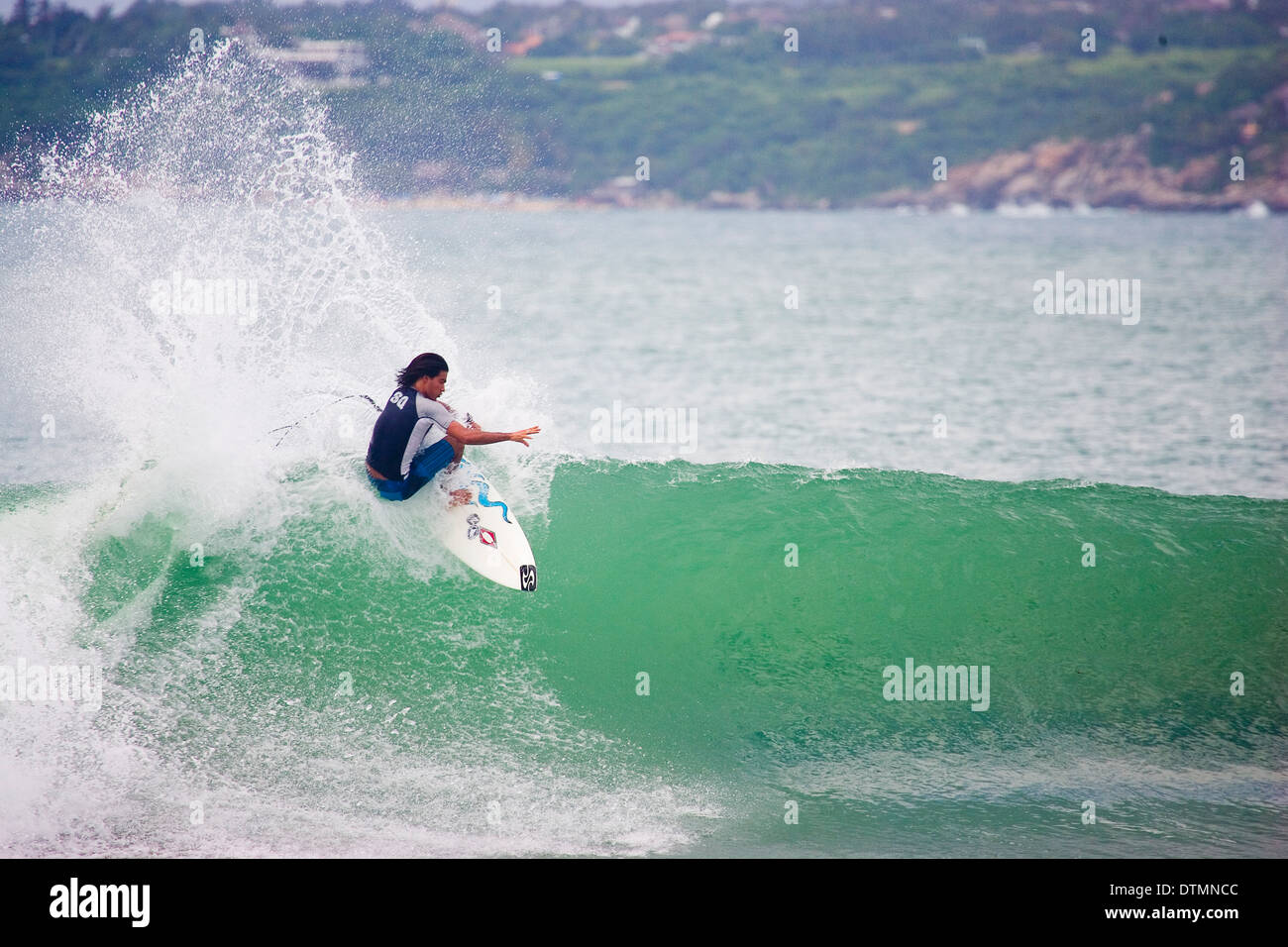 surfer on a surfboard riding a wave in the ocean sea water wave beach ...