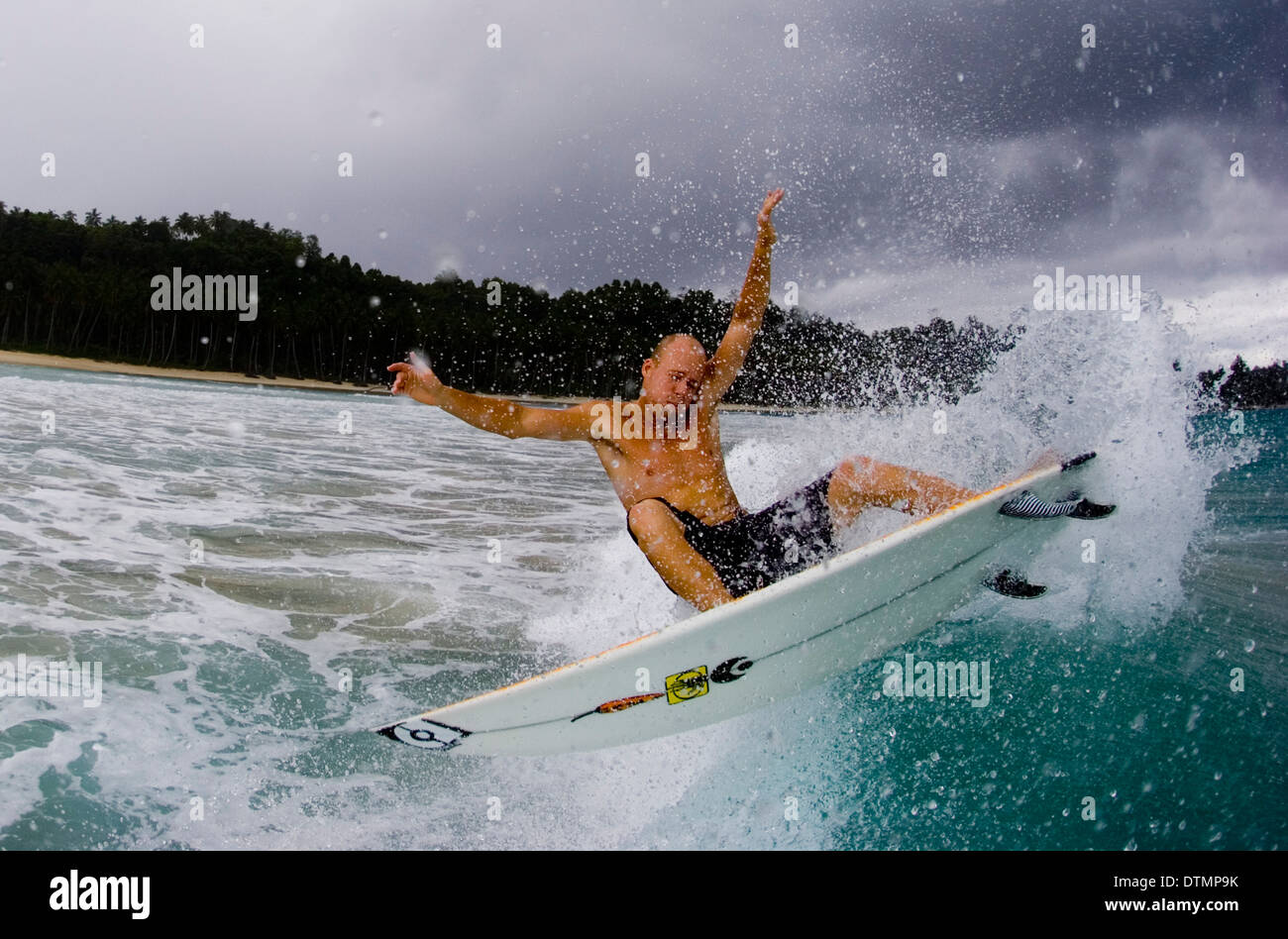 surfer on a surfboard riding a wave in the ocean sea water wave beach ...