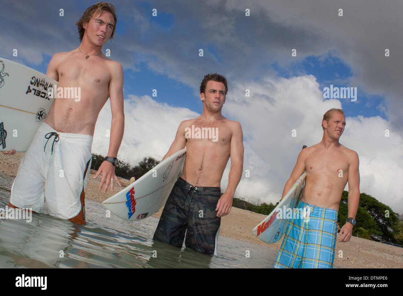 three guys dudes hang out in the shallow water and look out into the ...