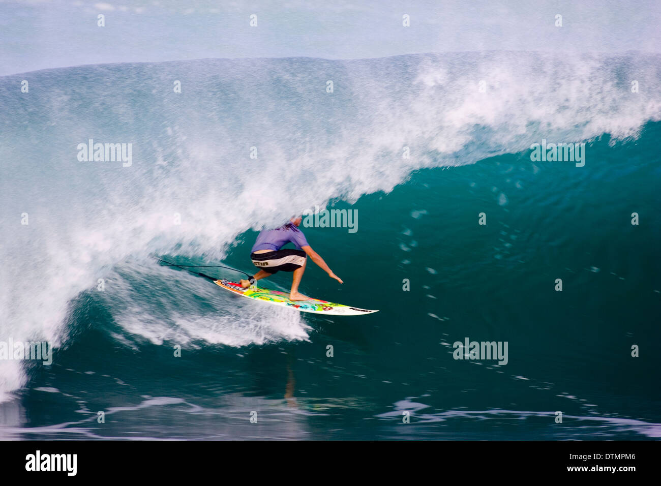 surfer on a surfboard riding a wave in the ocean sea water wave beach ...