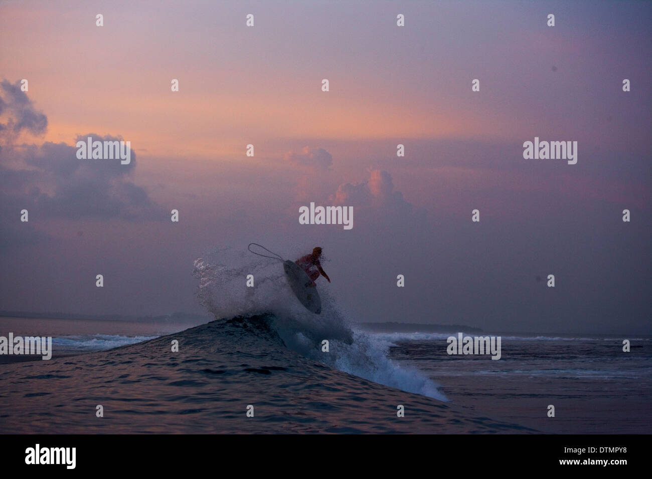 surfer on a surfboard riding a wave in the ocean sea water wave beach ...