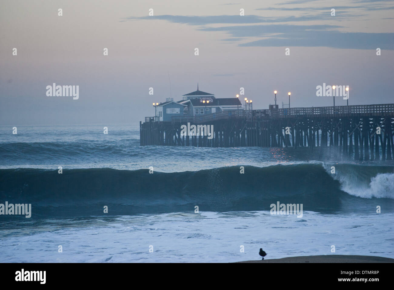 seal beach california pier with large huge massive waves crashing ...