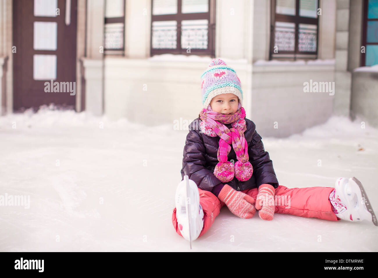 Little adorable girl sitting on ice after the fall Stock Photo - Alamy