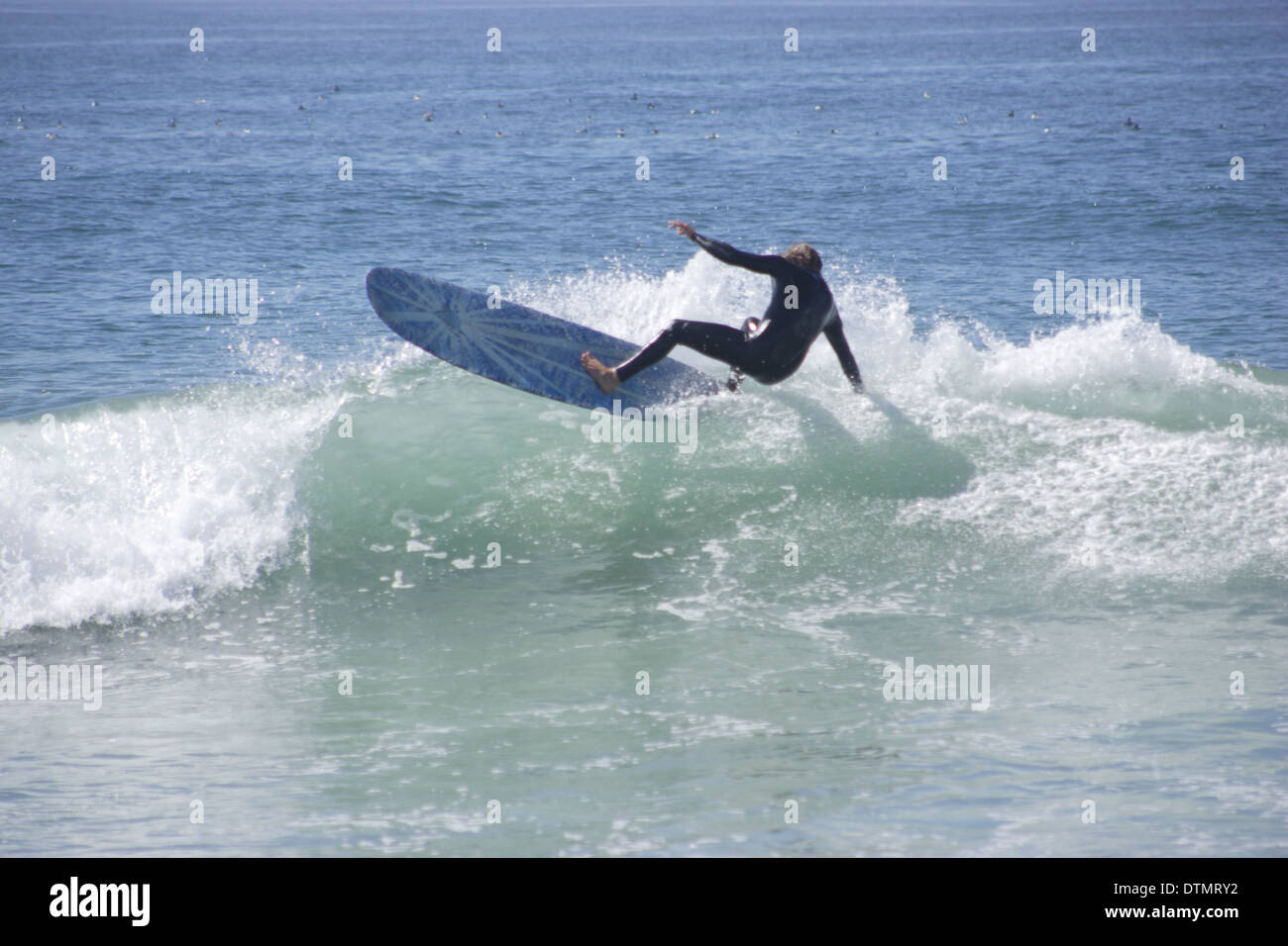 surfer on a surfboard riding a wave in the ocean sea water wave beach ...
