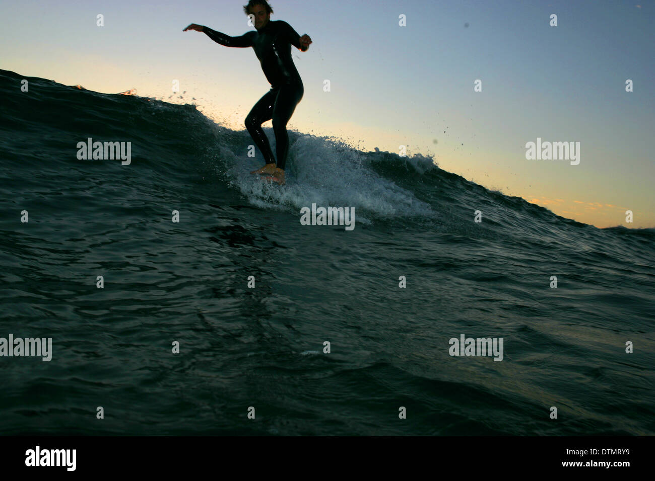 surfer on a surfboard riding a wave in the ocean sea water wave beach ...