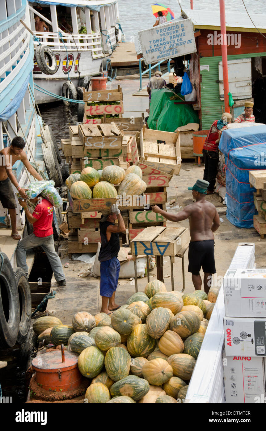Brazil, Amazon, Manaus. Busy waterfront pier where local riverboats are ...