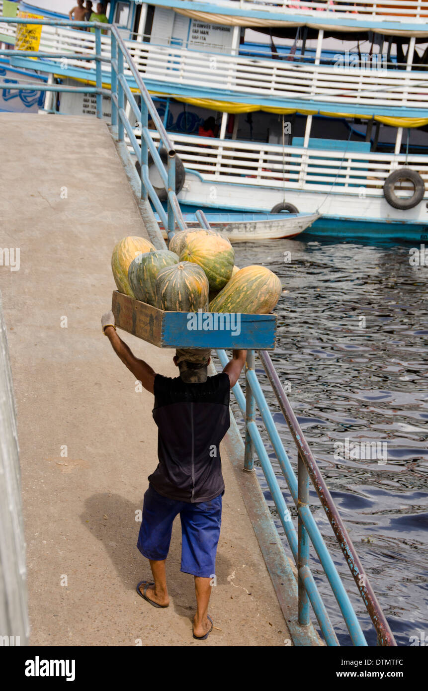 Brazil, Amazon, Manaus. Busy waterfront pier where local riverboats are ...