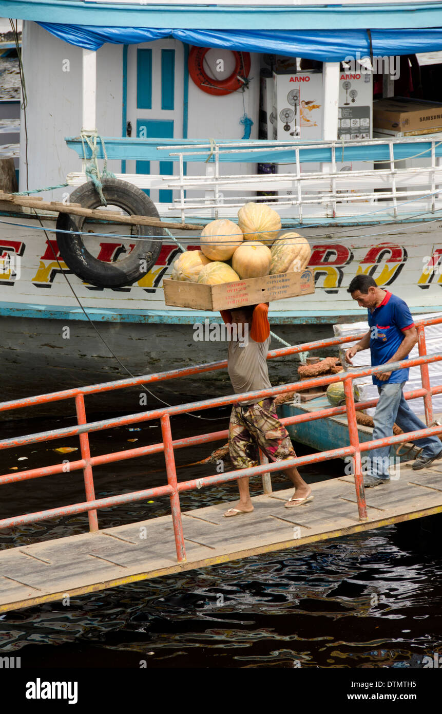 Brazil, Amazon, Manaus. Busy waterfront pier where local riverboats are ...